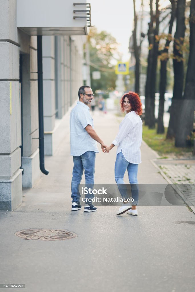 Cute European Middleaged Couple Holding Hands Walking In The City
