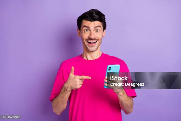 Photo Of Funky Sweet Young Guy Dressed Pink Tshirt Pointing Finger