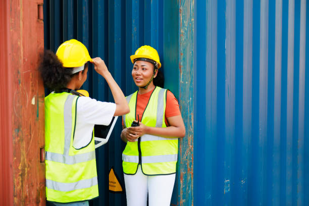 Free Stock Photo of Two Black female dock workers relax and talk ...