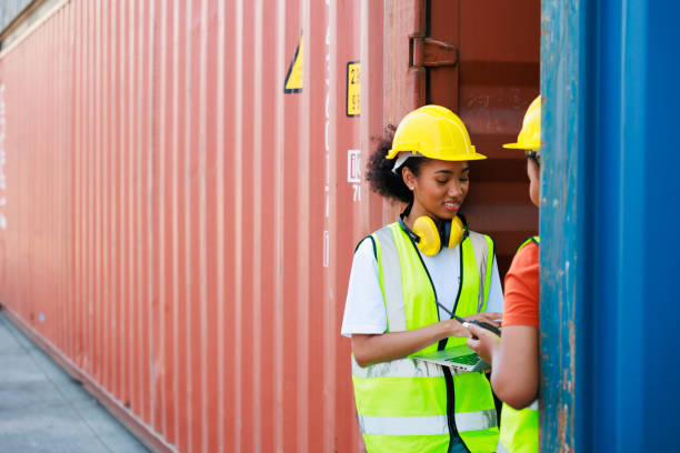 Free Stock Photo of Two Black female dock workers relax and talk ...