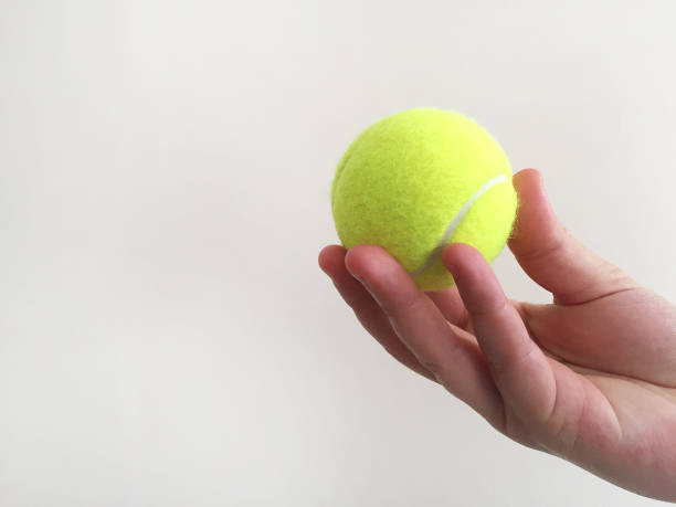 Free Stock Photo of Hand Holding Tennis Ball on White Surface ...