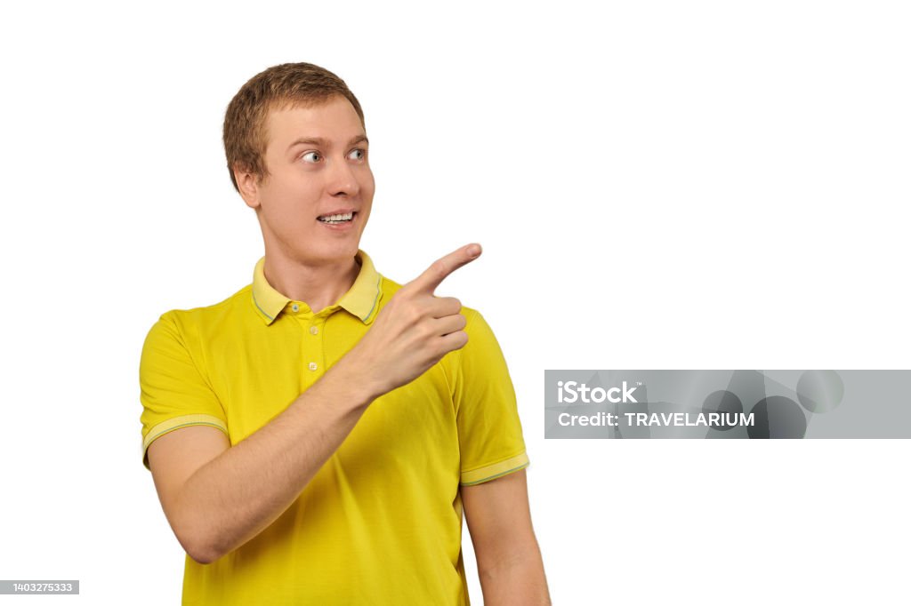 Surprised Guy With Funny Face In Bright Yellow Tshirt Pointing Finger