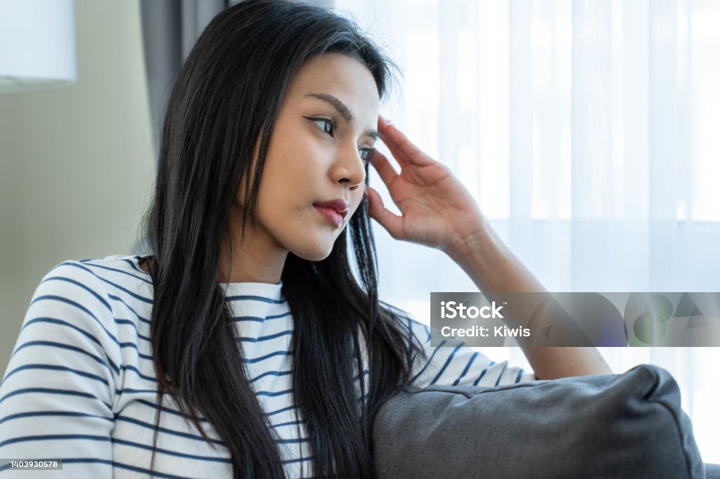 Asian Beautiful Upset Depressed Girl Sitting Alone On Bed In Bedroom