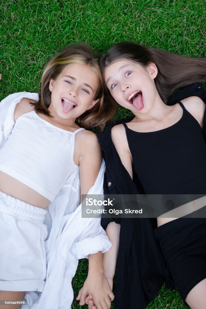 Fraternal Twins Sisters Blonde And Brunette Teen Girls In Fashionable
