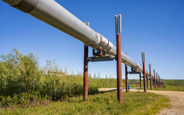 Free Stock Photo of A curved metal pipeline over an urban river ...