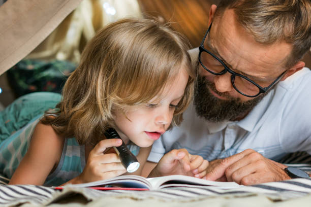 Free Stock Photo of Father and son reading with a flashlight | Download ...
