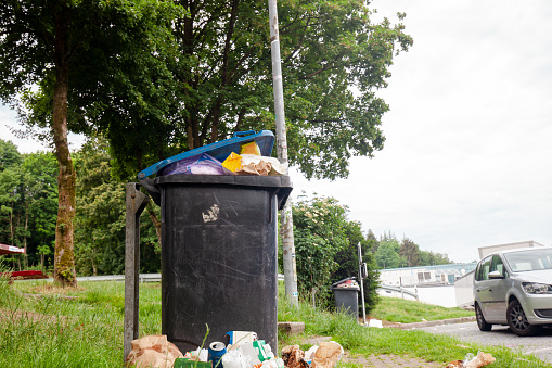 Overflowing Trash Can In The Parking Area Road Rest Area Near Highway