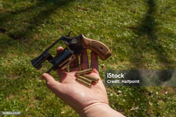 Unrecognizable Man Holding Revolver With Bullets In His Hand Closeup ... Unrecognizable Man Holding Revolver With Bullets In His Hand Closeup ...