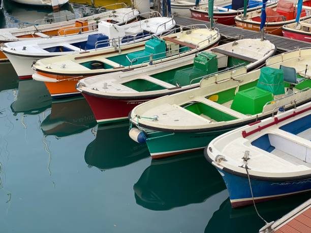 Free Stock Photo of Colorful boats docked at a calm waterside ...