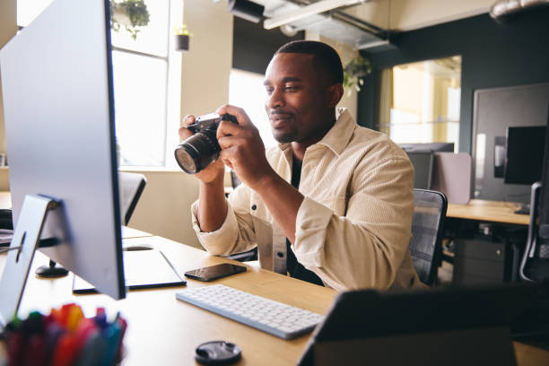 Free Stock Photo of Man wearing black hat holding professional camera ...