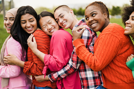 Multiracial Female Friends Having Fun Hugging Together Outdoor Stock