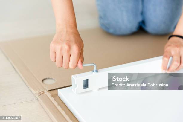 Woman Hand Screwing Screw In White Plank Using Hex Key Assembling New