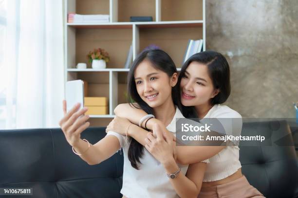 Asian Lesbian Couple Lgbtq Lesbian Couple Holding Smartphone And Posing