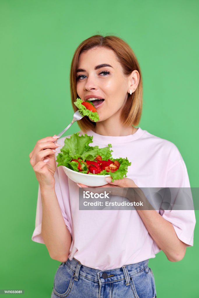 Beautiful Woman Eating Fresh Vegetable Salad On White Background Stock