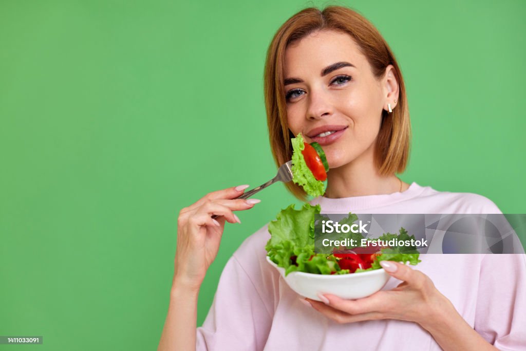 Beautiful Woman Eating Fresh Vegetable Salad On White Background Stock