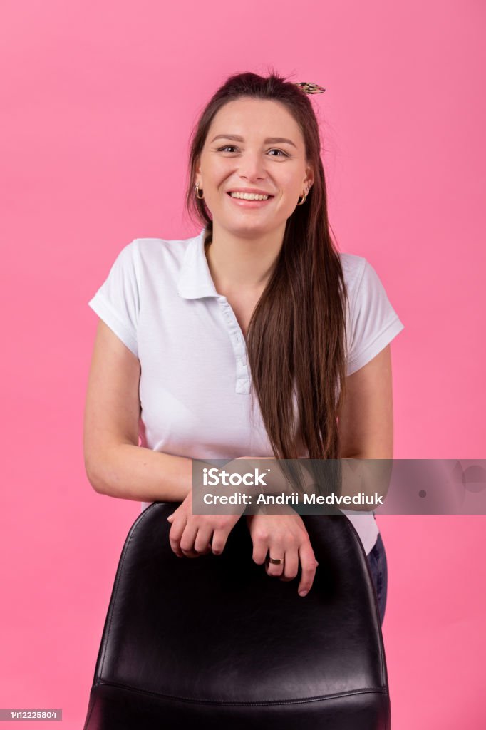 Portrait Of Happy Female With Smile Wears Casual White T Shirt Poses