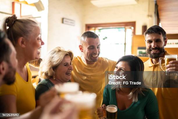 Penggemar Olahraga Kuning Dan Hijau Merayakan Dan Minum Bir Di Bar Foto ... Penggemar Olahraga Kuning Dan Hijau Merayakan Dan Minum Bir Di Bar Foto ...