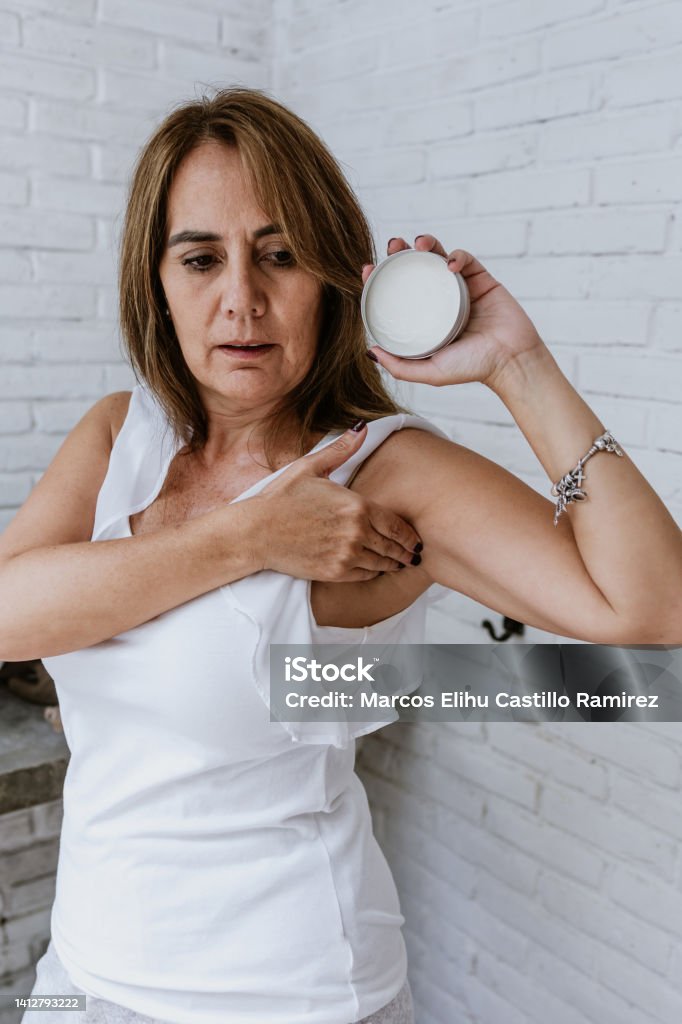 Hispanic Senior Middle Aged Woman After Shower Using Antiperspirant Or