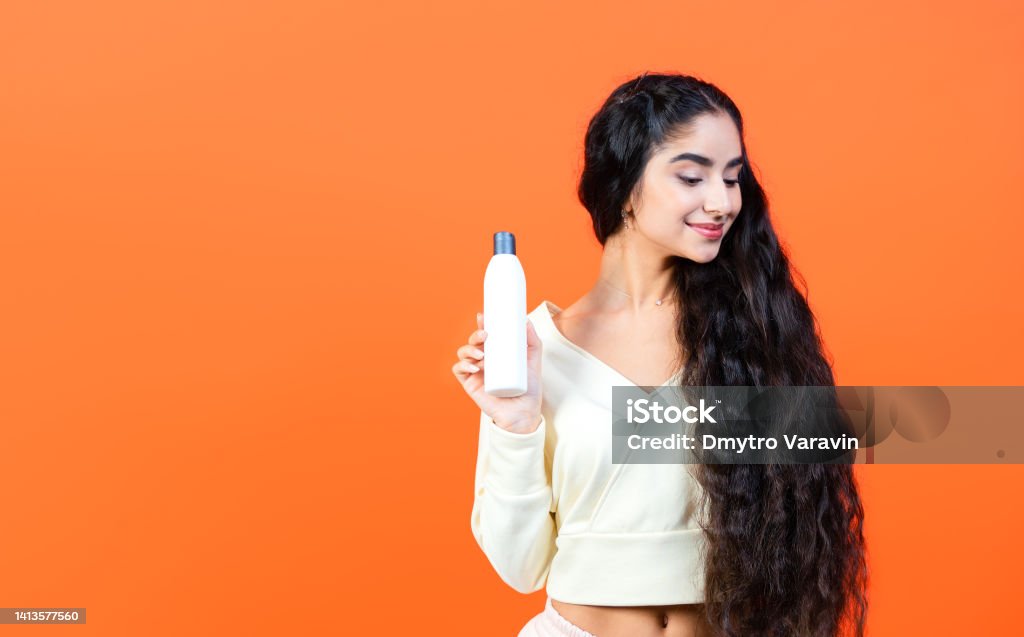 Beautiful Indian Ethnicity Woman Admiring Her Long Healthy Hair Thanks To The White Blank