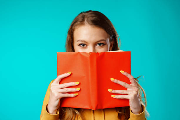 Free Stock Photo of Woman Hiding Face Behind Book | Download Free ...