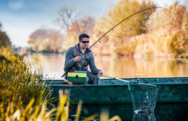 Free picture: Fisherman sitting in wooden boat and fishing