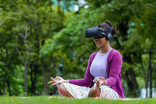 African American Woman Relaxingly Practicing Meditation In The Forest