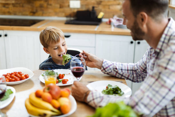 Free Stock Photo of Dad feeding his distracted son | Download Free ...