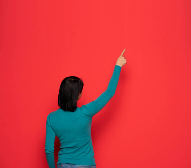 Free Stock Photo of Woman pointing at blank copyspace above her head ...