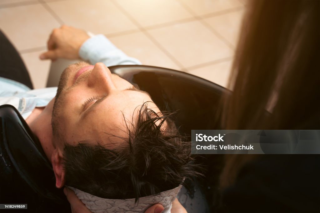 Hair Salon Master Washing Client Hair At Barber Shop Male Client