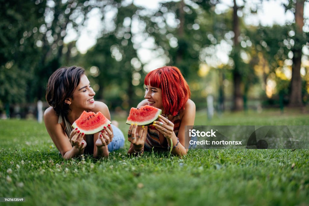 Lovely Lesbian Girls Looking At Each Other Eating A Watermelon Stock