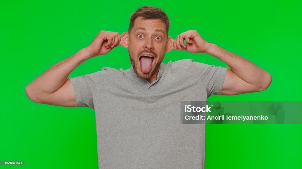 Funny Man Making Playful Silly Facial Expressions And Grimacing Fooling