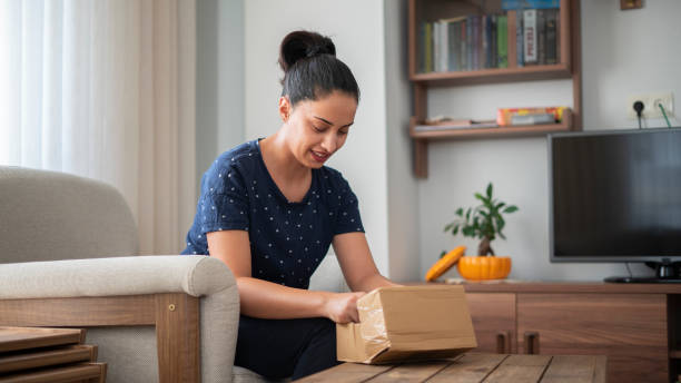 Free Stock Photo of Lifestyle. Woman opening a box at her desk ...