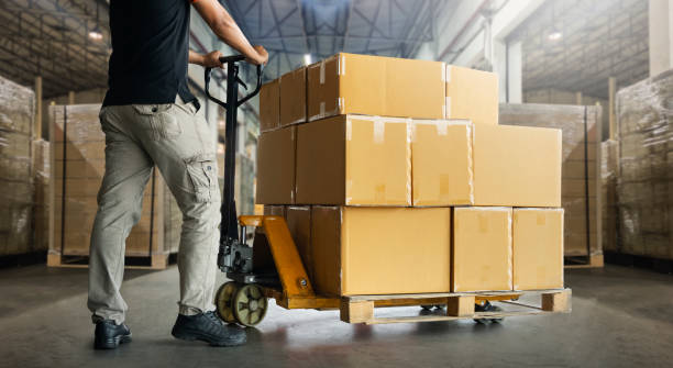 Workers Unloading Packaging Boxes on Pallets in Warehouse. Cartons ...