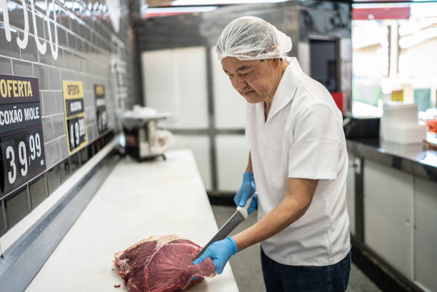 Free Stock Photo of Butcher in a butcher s shop weighing the meat and ...