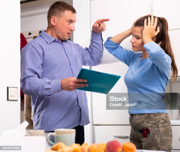 Frustrated Woman Talking To Debt Collector Visiting Her At Home And