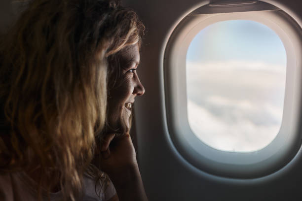 Free Stock Photo of Woman Looking Out Airplane Window at Ocean ...