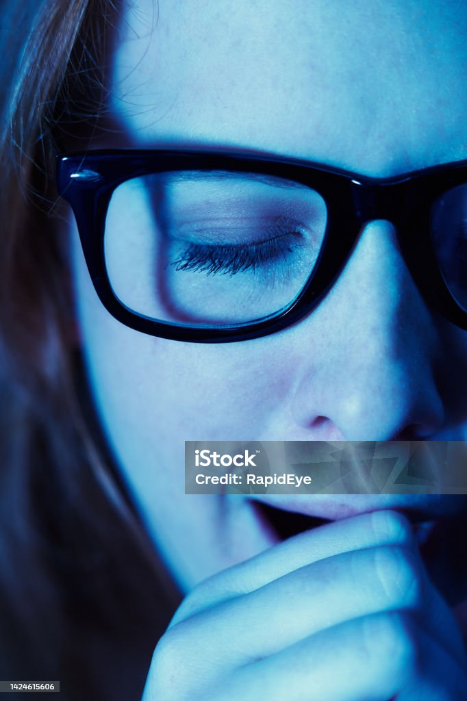 Sleepy Young Woman In Nerd Glasses Yawns Covering Her Open Mouth With