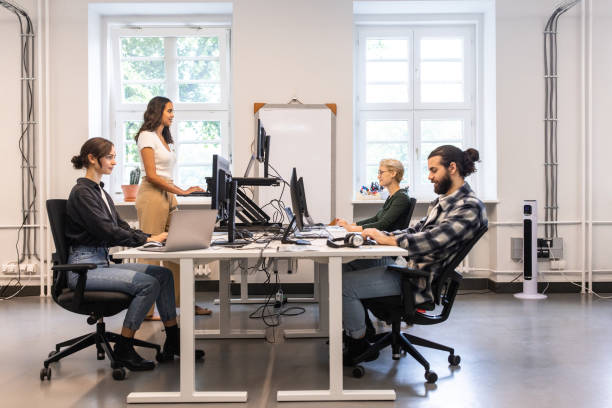 Free Stock Photo of Group of People Sitting at Desks in a Room ...