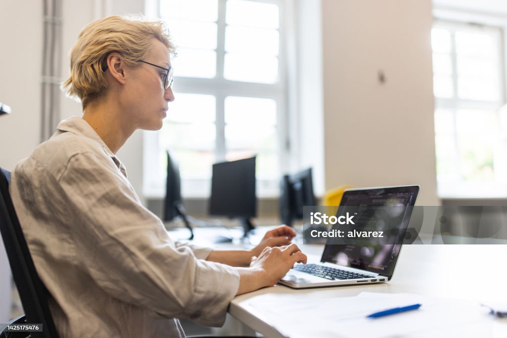 Woman Coding On Laptop Working At A Coworking Office Stock Photo ... Woman Coding On Laptop Working At A Coworking Office Stock Photo ...