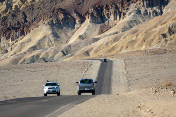 Free Stock Photo of A Car Driving Down a Dirt Road in the Desert ...