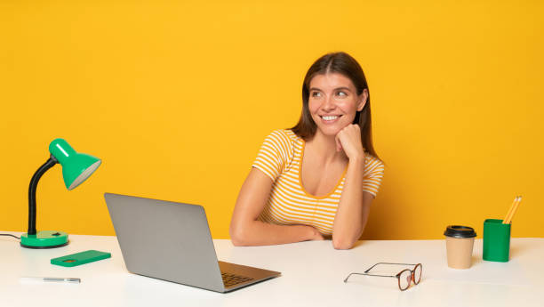 Free picture: Pretty young woman sitting at a desk with a laptop ...