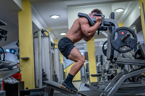 Man Doing Quadriceps Exercise On Hack Squat Machine At Gym Stock Photo ... Man Doing Quadriceps Exercise On Hack Squat Machine At Gym Stock Photo ...