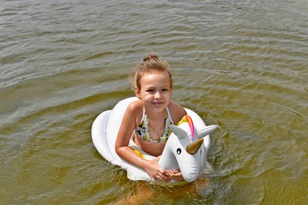 Free Stock Photo of Girl playing on inflatable goose at the beach ...
