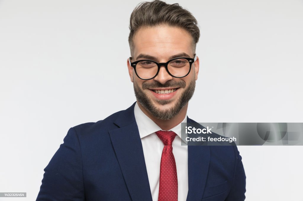 Portrait Of Happy Man In Elegant Suit With Red Tie Wearing Glasses