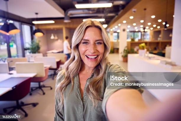 Pov Selfie Portrait Of Businesswoman Standing In Modern Open Plan