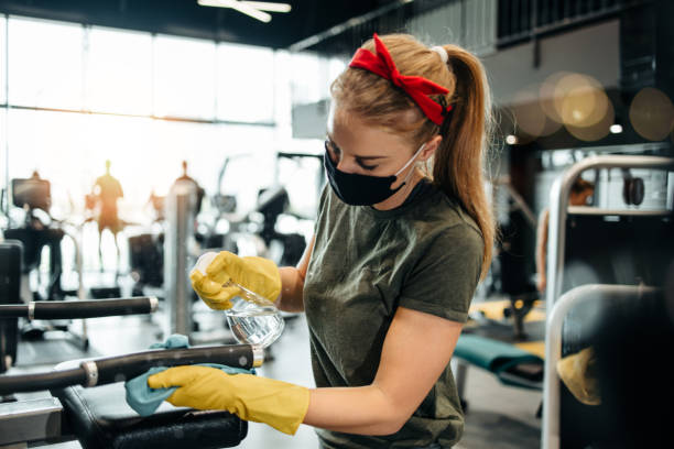 Free Stock Photo of Fitness staff cleaning exercise machines alcohol ...