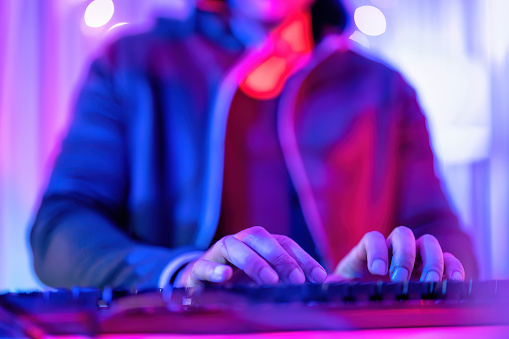 Somewhere In The Room Hacker Wearing Hood Jacket Typing Computer