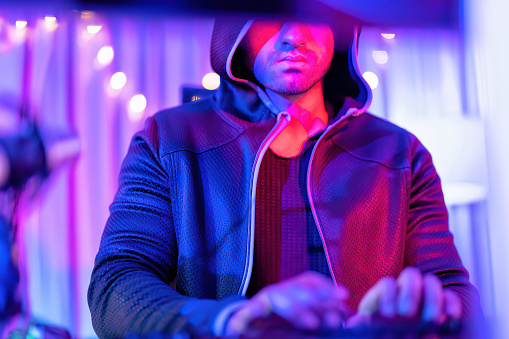 Somewhere In The Room Hacker Wearing Hood Jacket Typing Computer