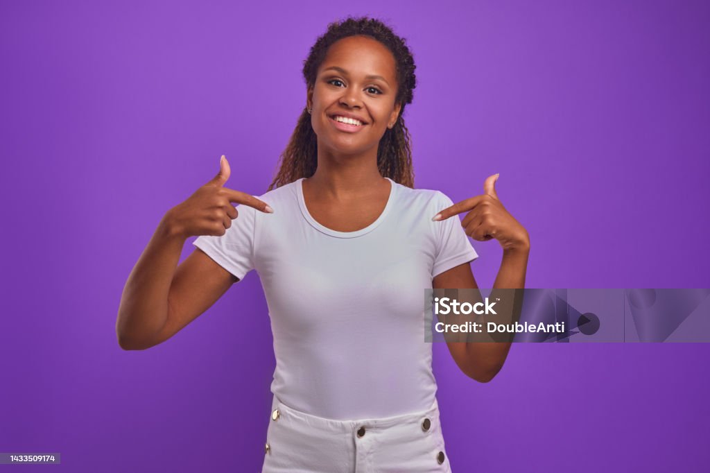 Young Smiling African American Woman Pointing At Snowwhite Tshirt Stock