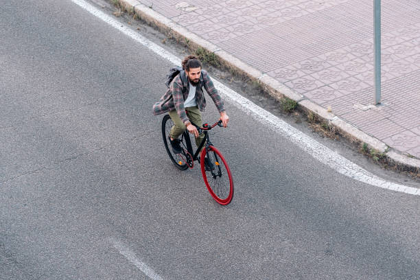 Free Stock Photo of Man Riding a Bike Down a Street | Download Free ...